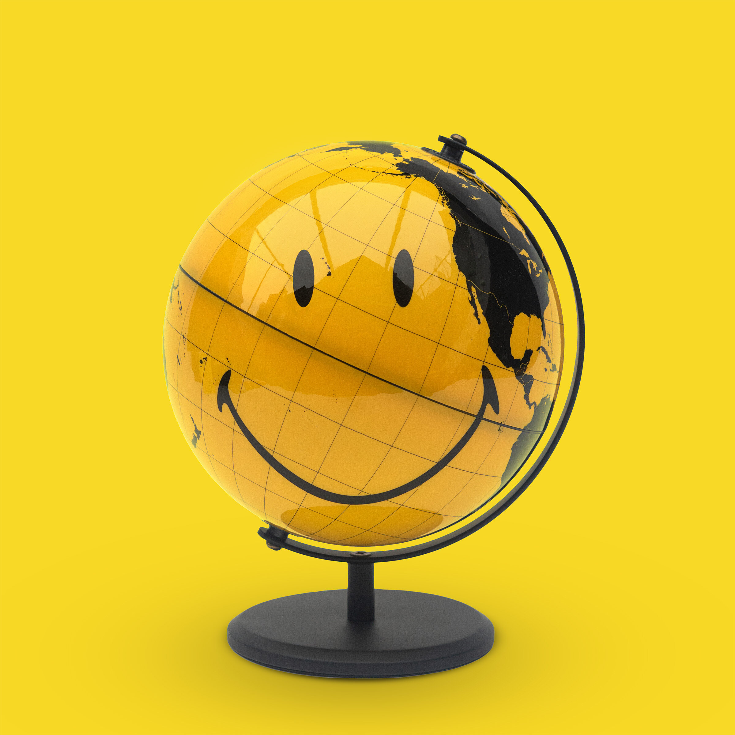 Smiley® Globe : Yellow globe with a smiley face.